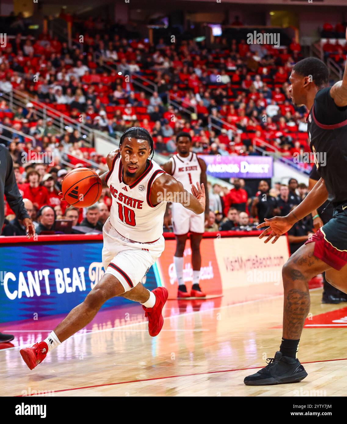 December 7, 2024: North Carolina State senior Marcus Hill (10) drives to basket. NCAA basketball ...