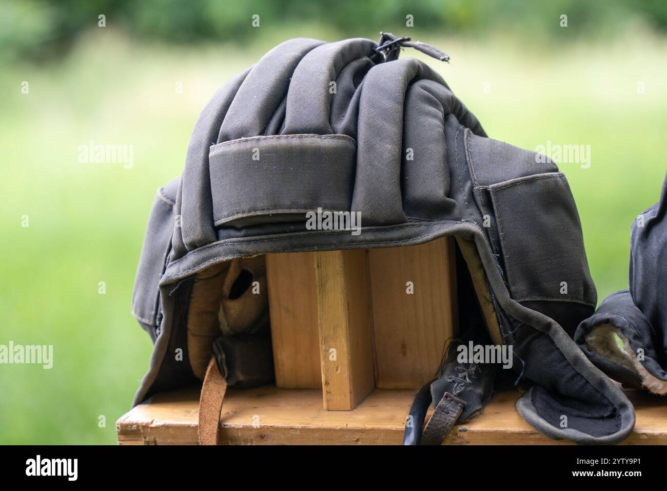 Old military tank crew helmet on wooden stand Stock Photo - Alamy