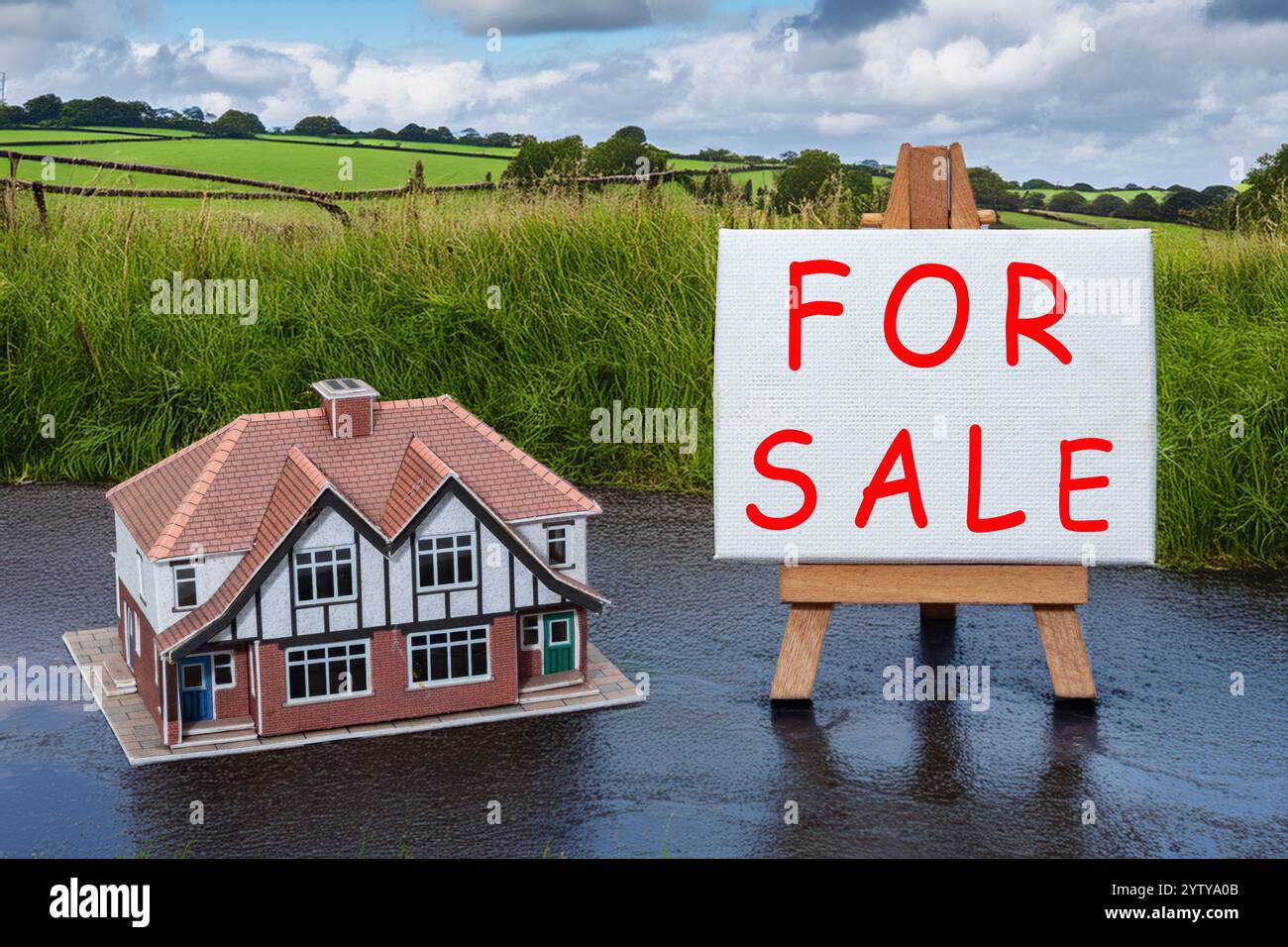 Model home with a For Sale sign with a countryside background Stock ...
