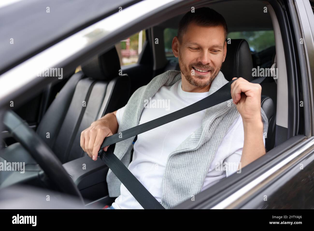 Man driving modern car, view through window Stock Photo - Alamy