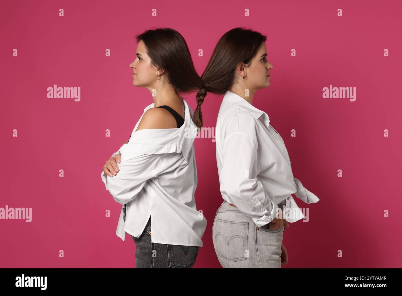 Portrait of beautiful twin sisters on pink background Stock Photo - Alamy