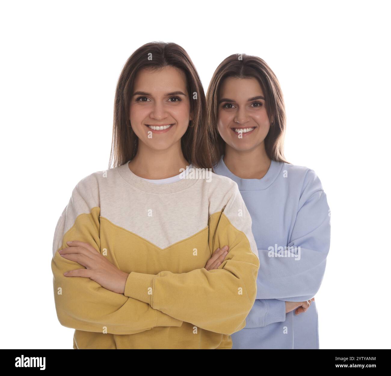 Portrait of beautiful twin sisters on white background Stock Photo - Alamy