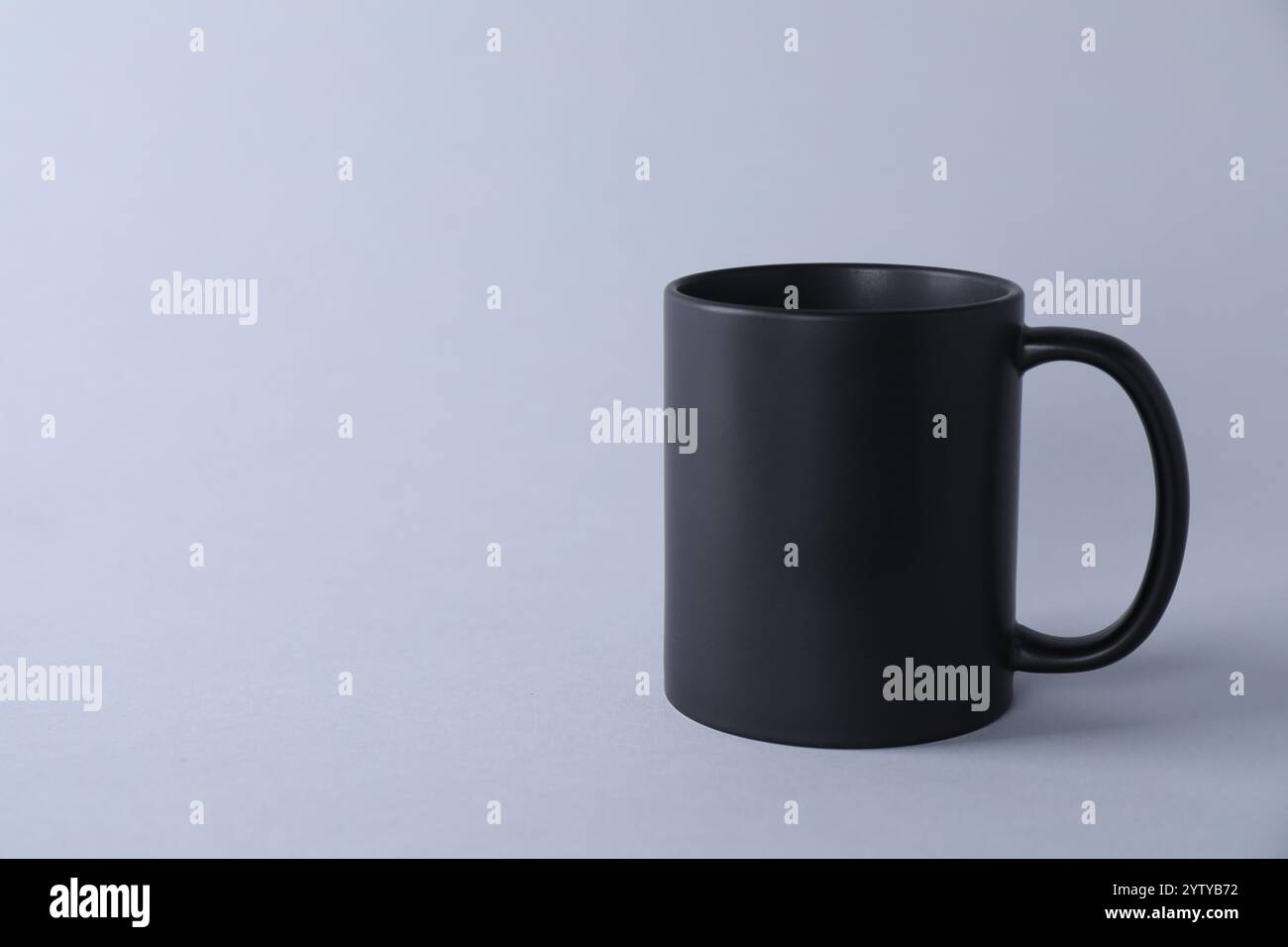 One blank black mug on light background. Mockup for design Stock Photo ...