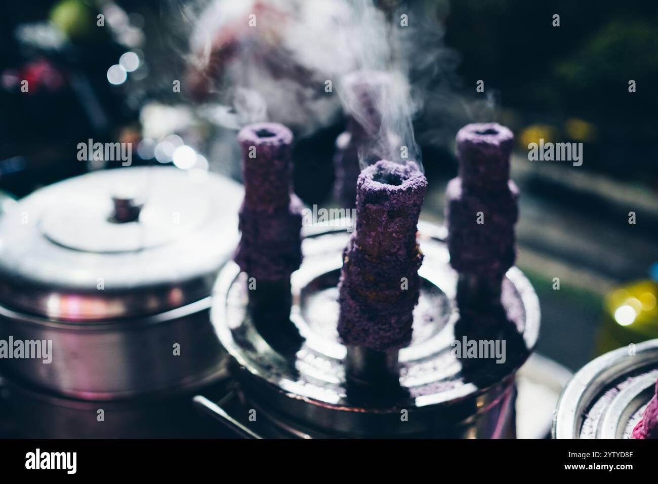 Cooking Puto bumbong, a popular Filipino delicacy of steamed purple ...