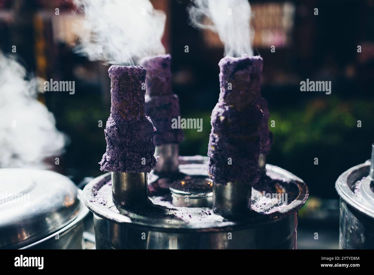 Cooking Puto bumbong, a popular Filipino delicacy of steamed purple ...
