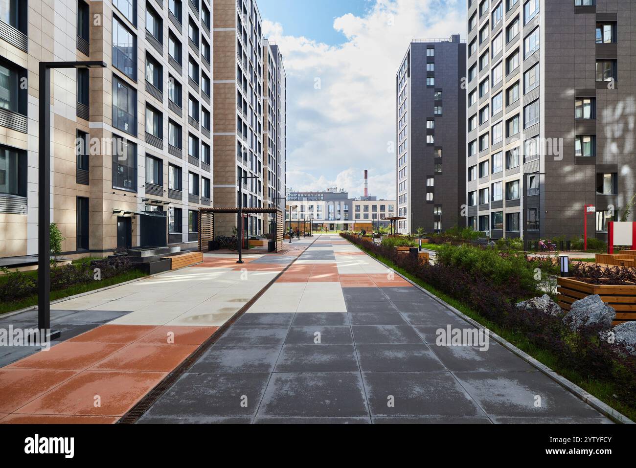 A modern urban residential complex featuring green spaces and ...