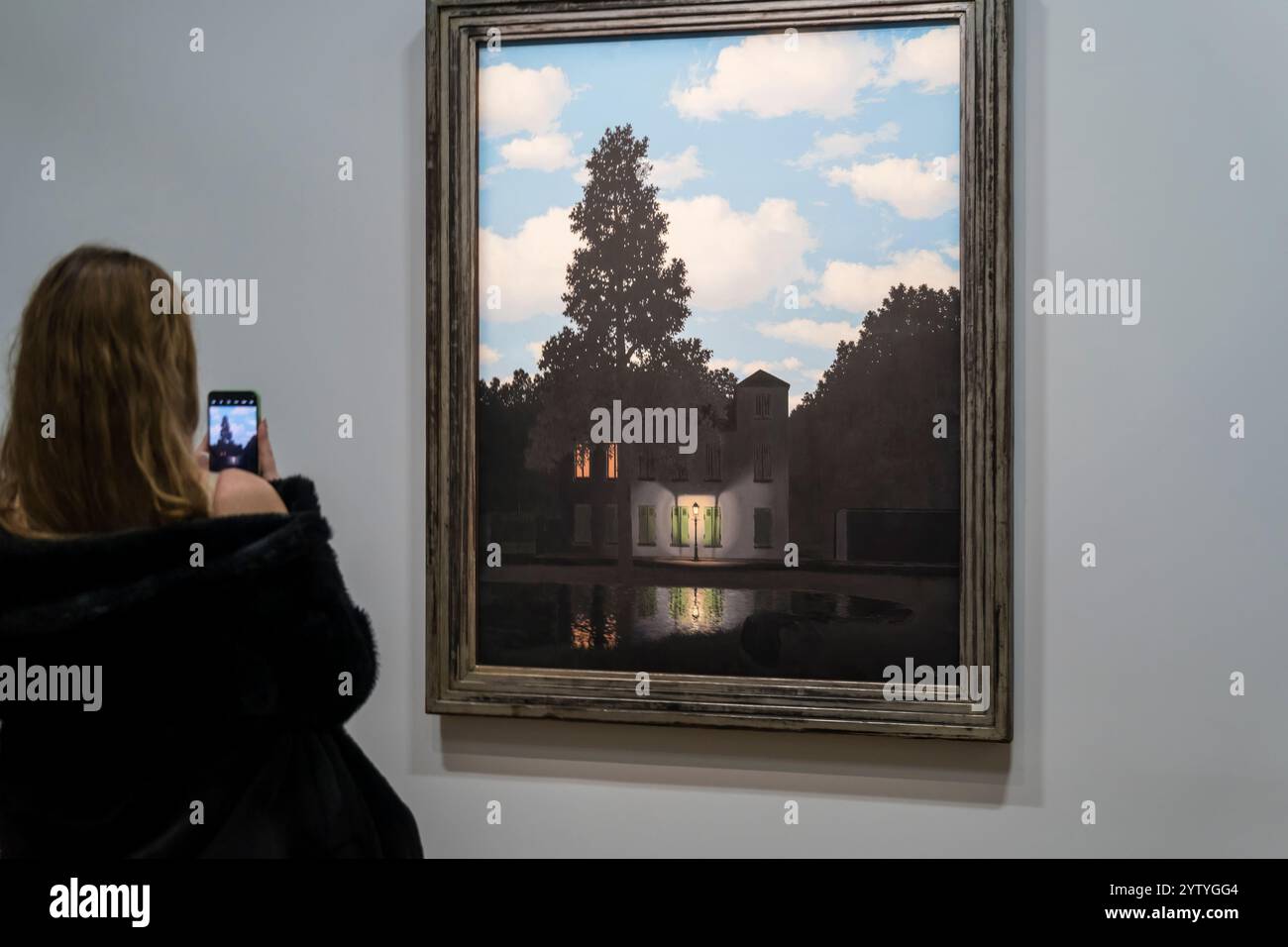 Visitor photographing L'Empire des lumières, by René Magritte Stock ...