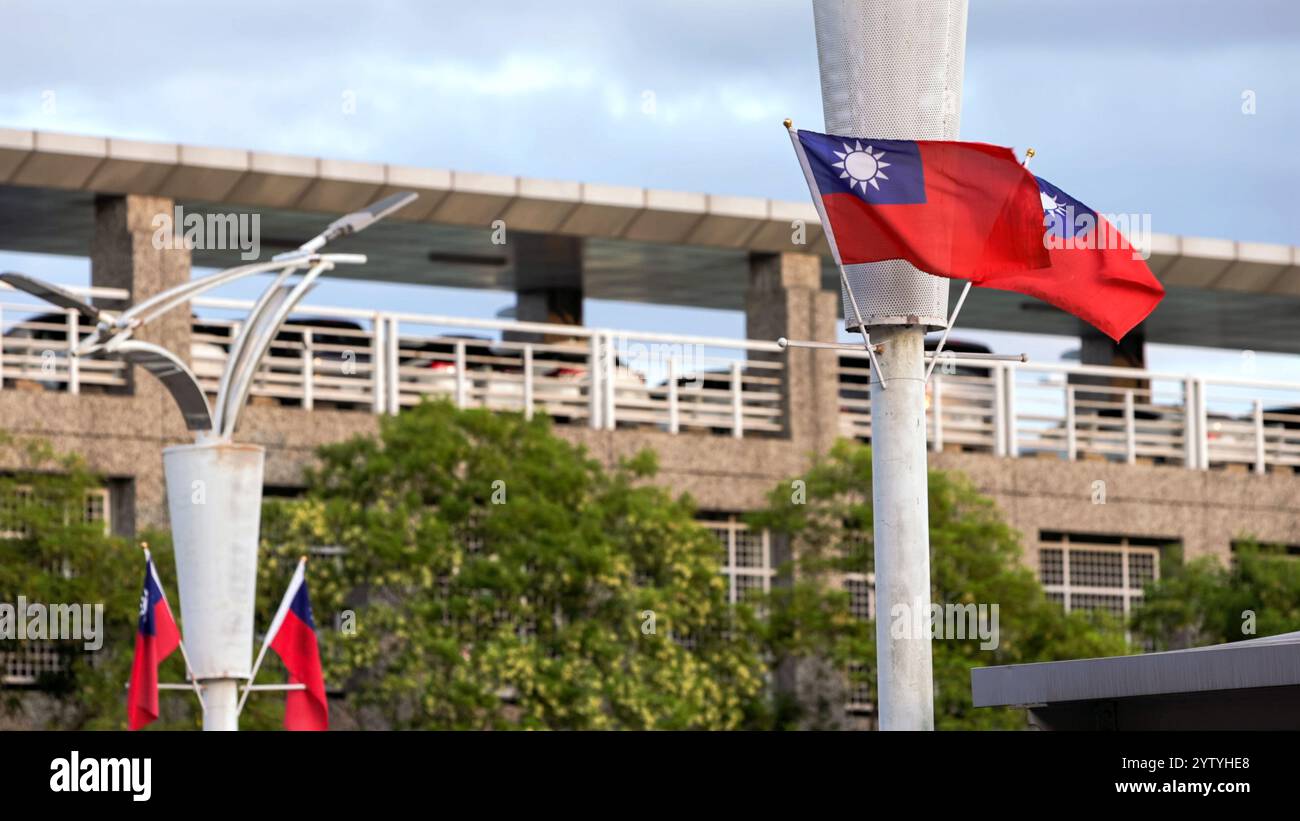 Taiwan flags displayed prominently on poles with a bustling urban ...