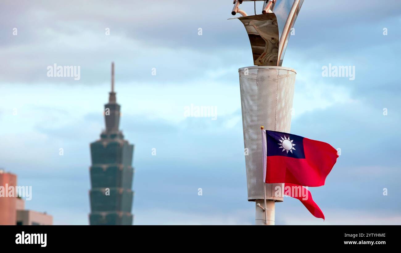 Taiwan flag waving in front of Taipei 101 during dusk, capturing a ...