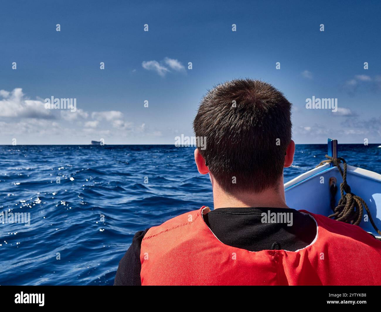 Rear view of a man looking at the sea from the boat Stock Photo - Alamy