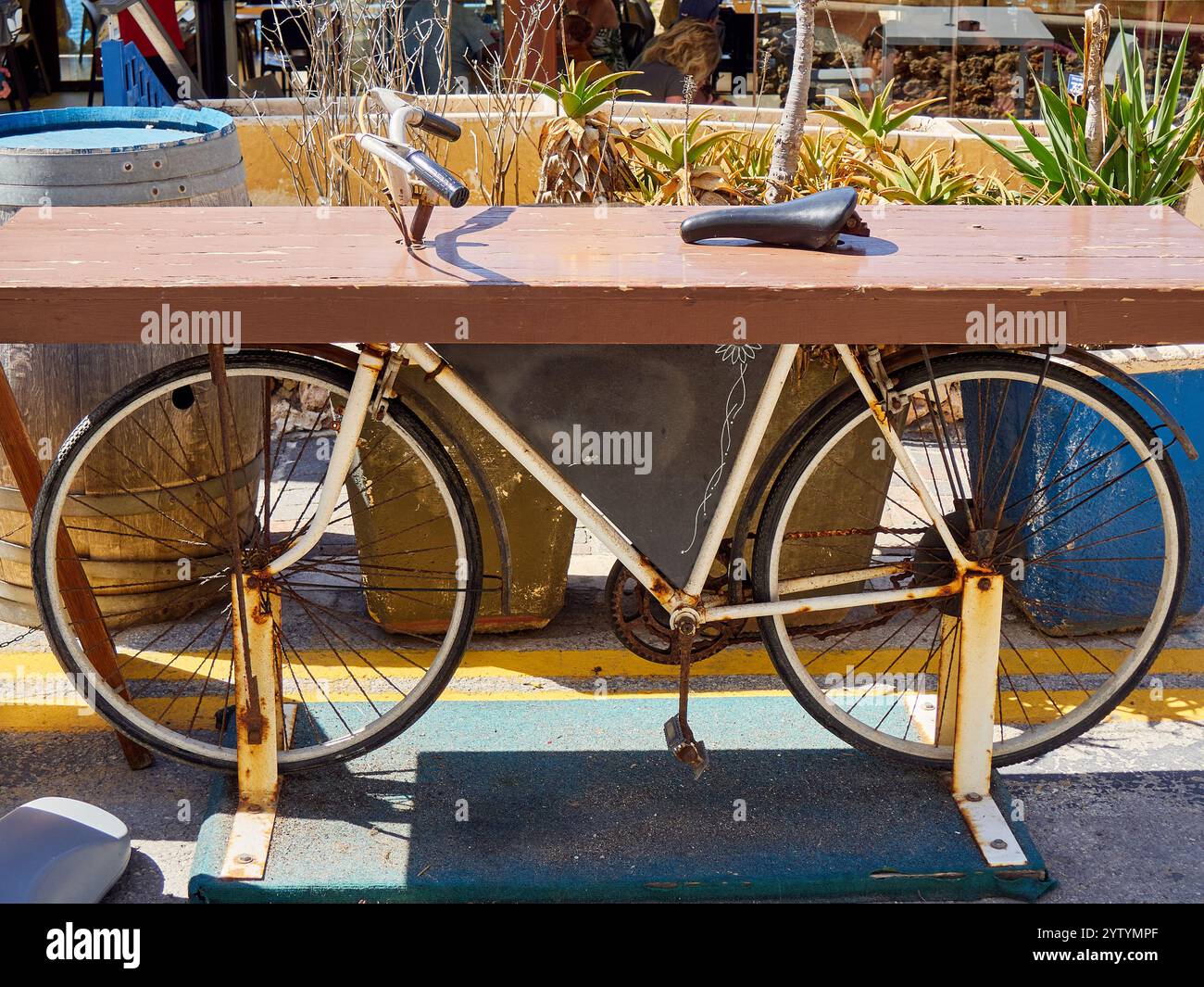 old bicycle converted into a table Stock Photo - Alamy