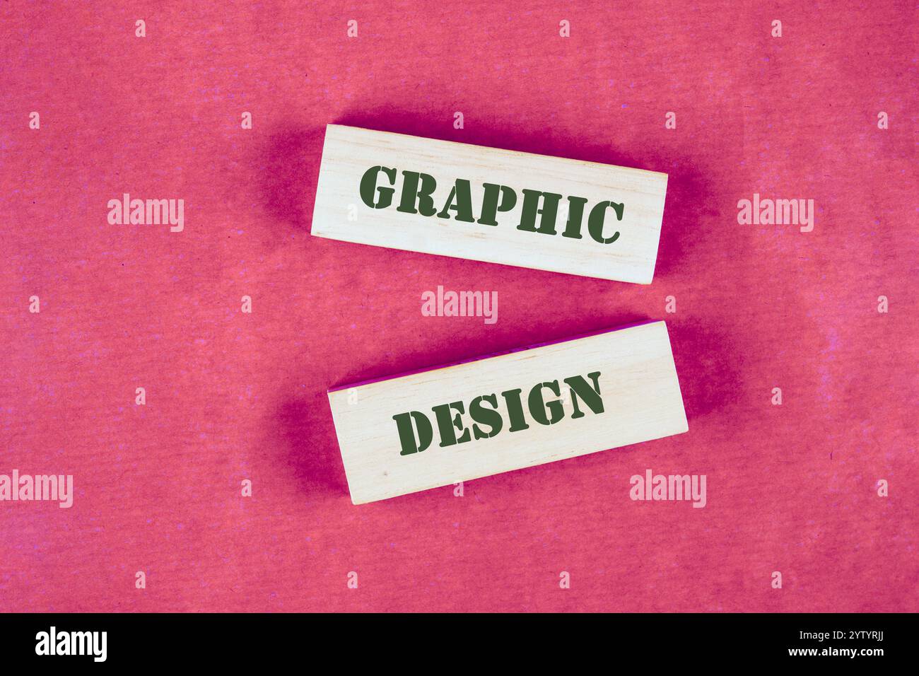 Two wooden blocks featuring the words graphic and design are placed ...