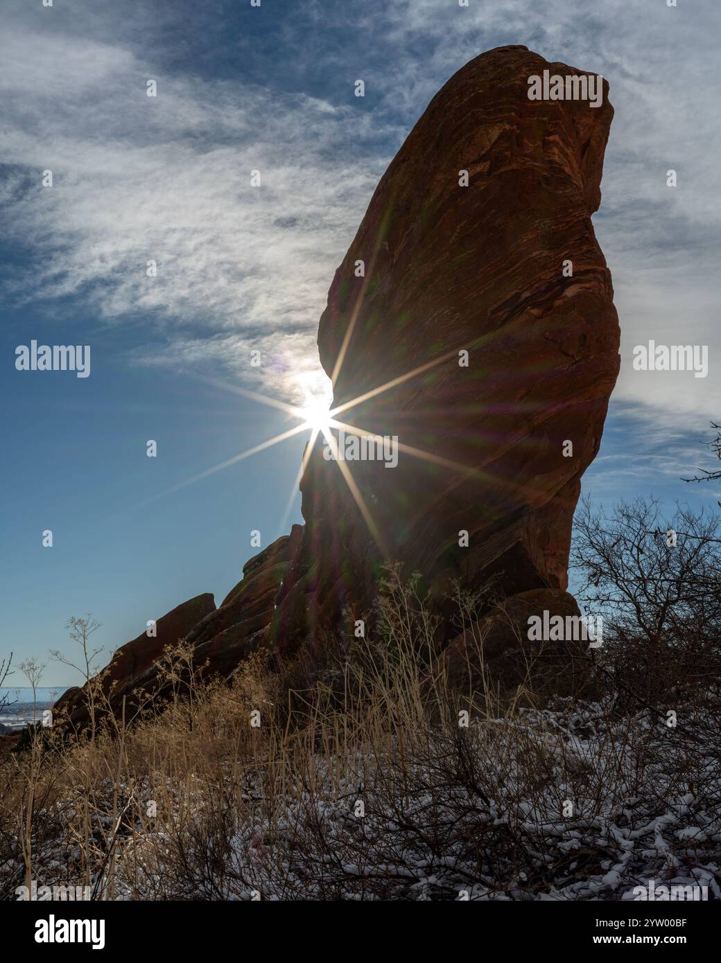Morning Sunburst peaks from behind a giant bolder in Colorado Stock ...