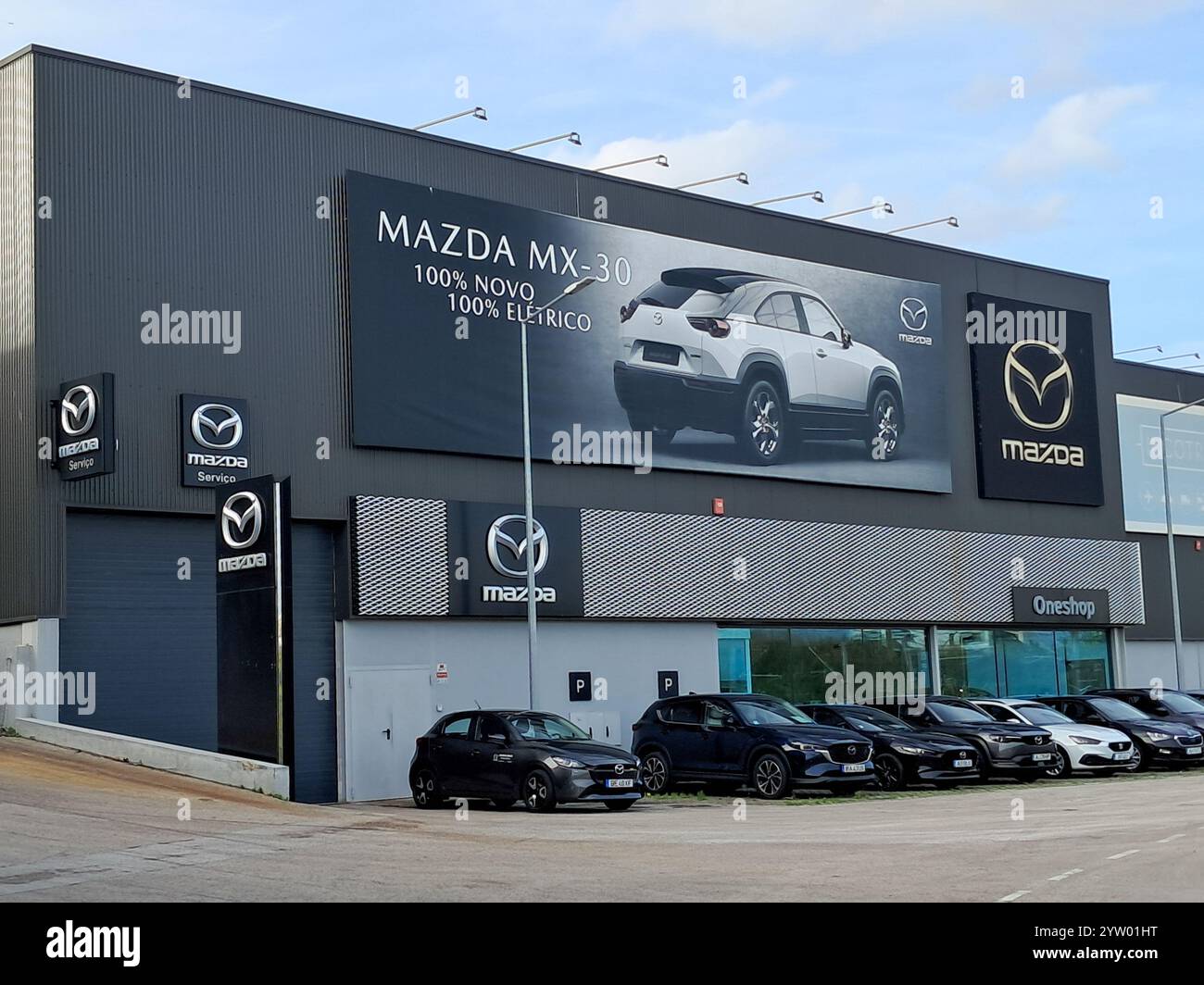 Mazda dealership promoting the electric mx 30 model with a large ...