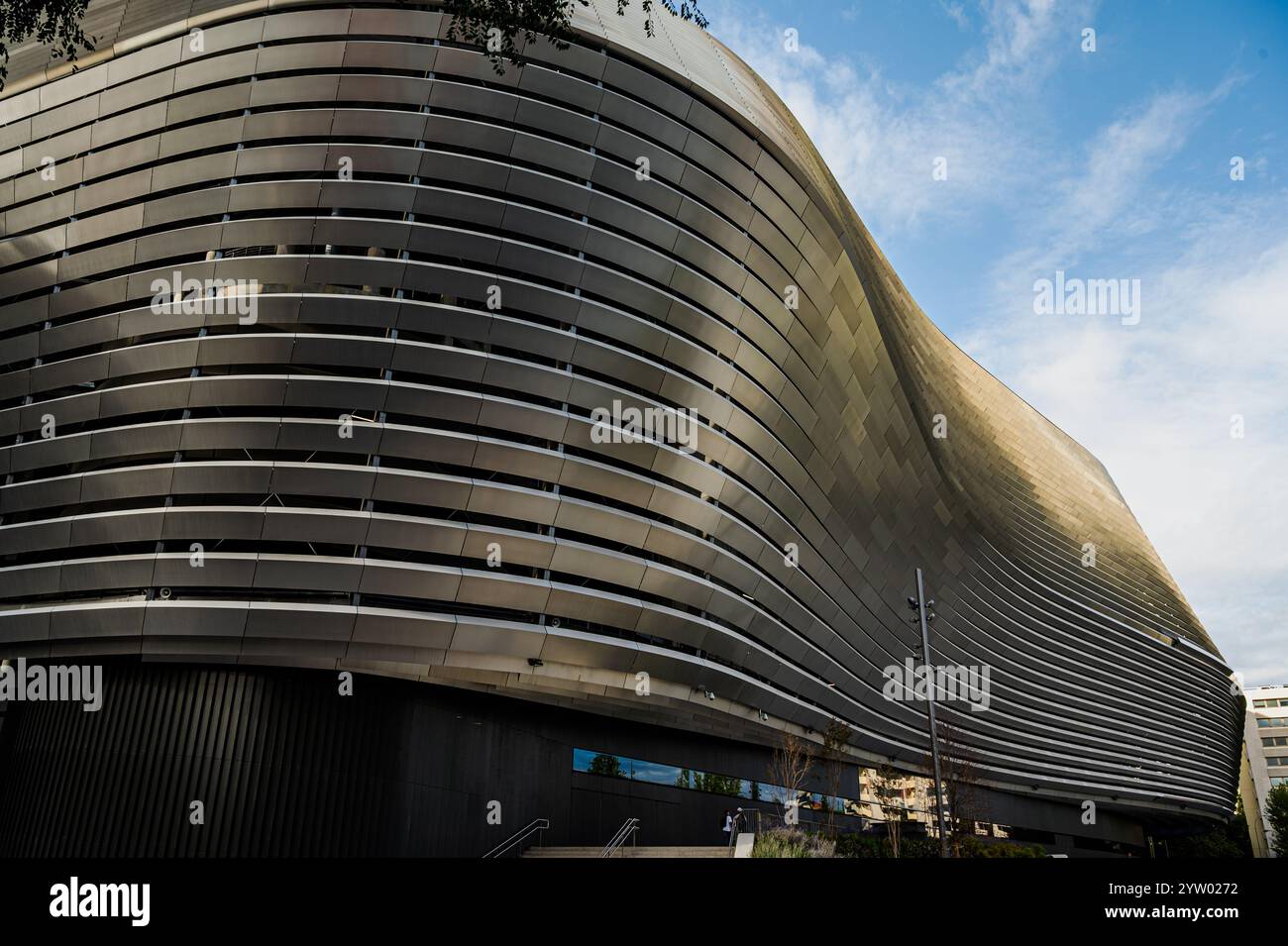 A large building with a lot of windows and a curved roof. The building ...