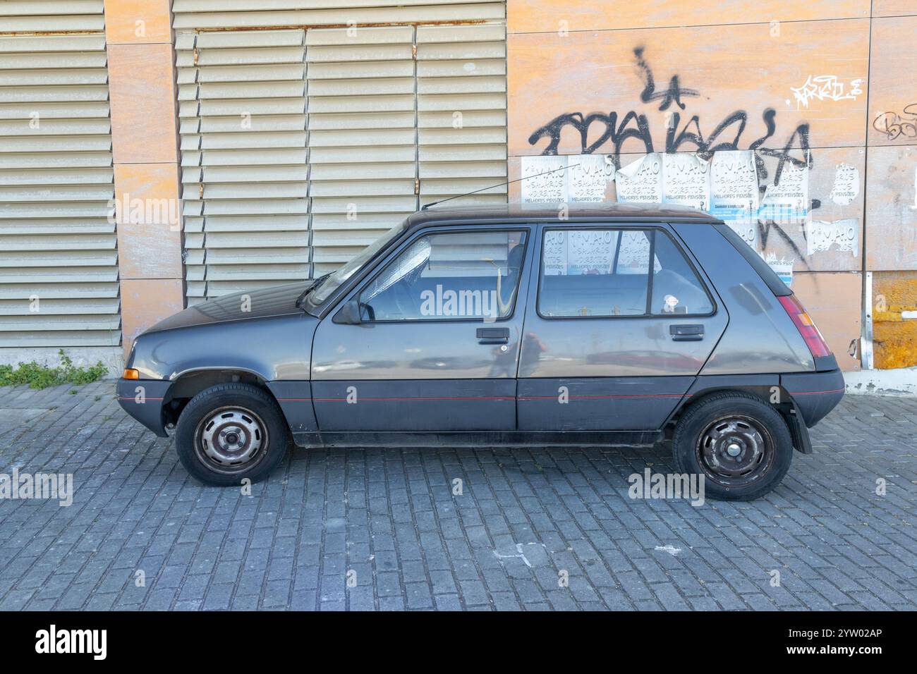 Side view of a grey renault 5 gtl parked on a brick pavement next to a ...