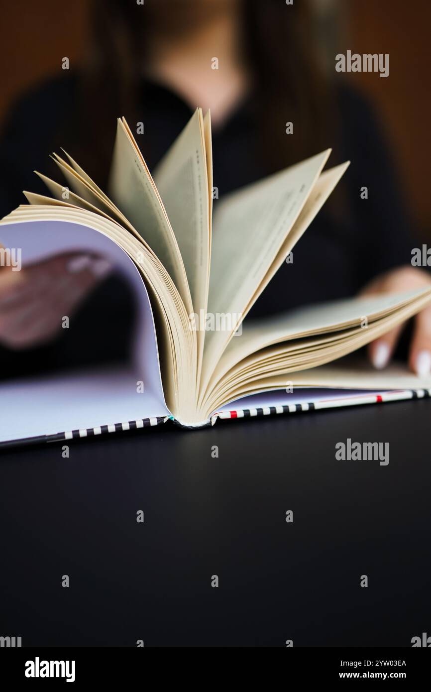 Artistic concept with open book pages on wooden surface, symbolizing ...