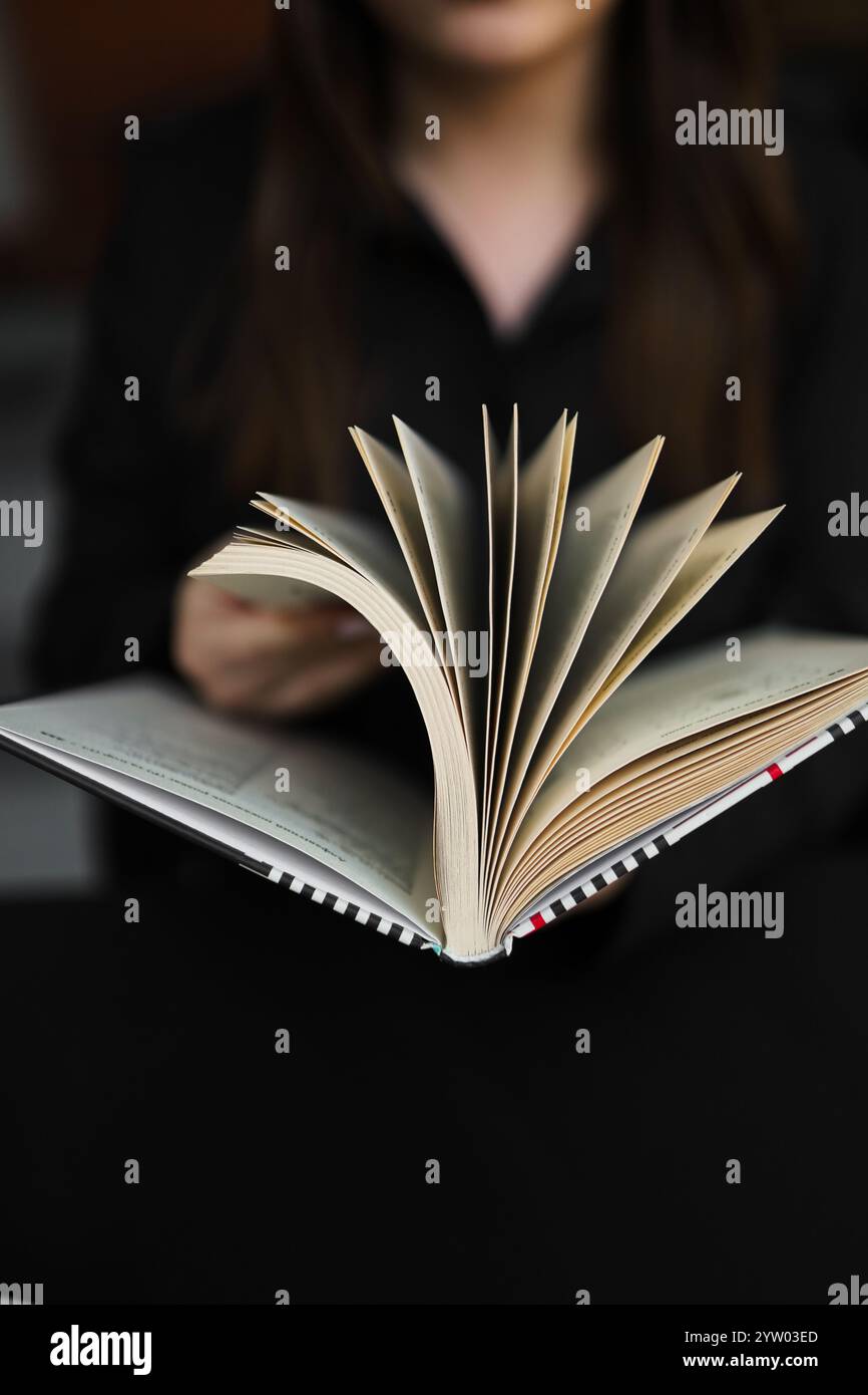 Artistic concept with open book pages on wooden surface, symbolizing ...