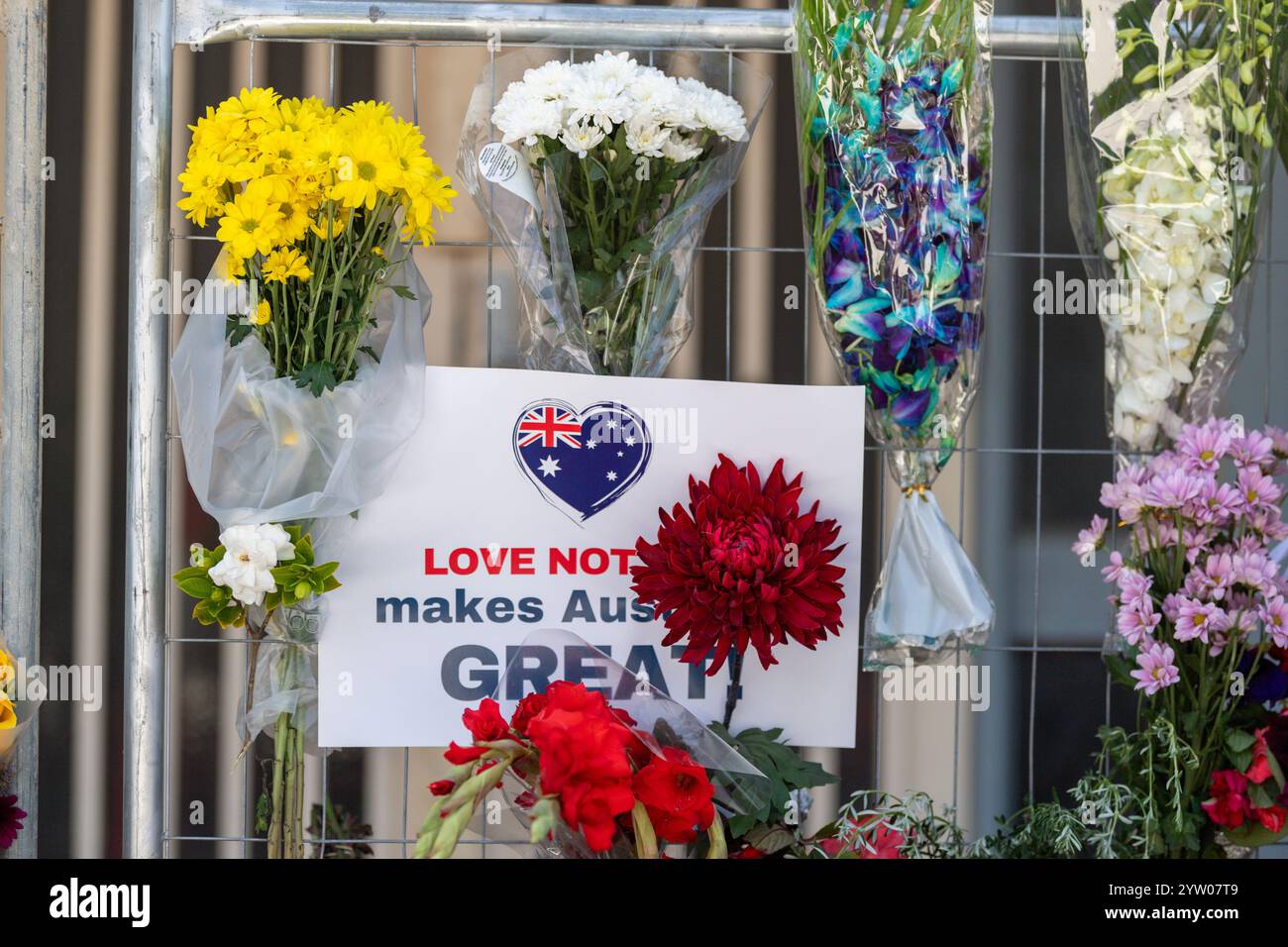 Signs and flowers in the temporary fence at the burnt Adass Israel ...