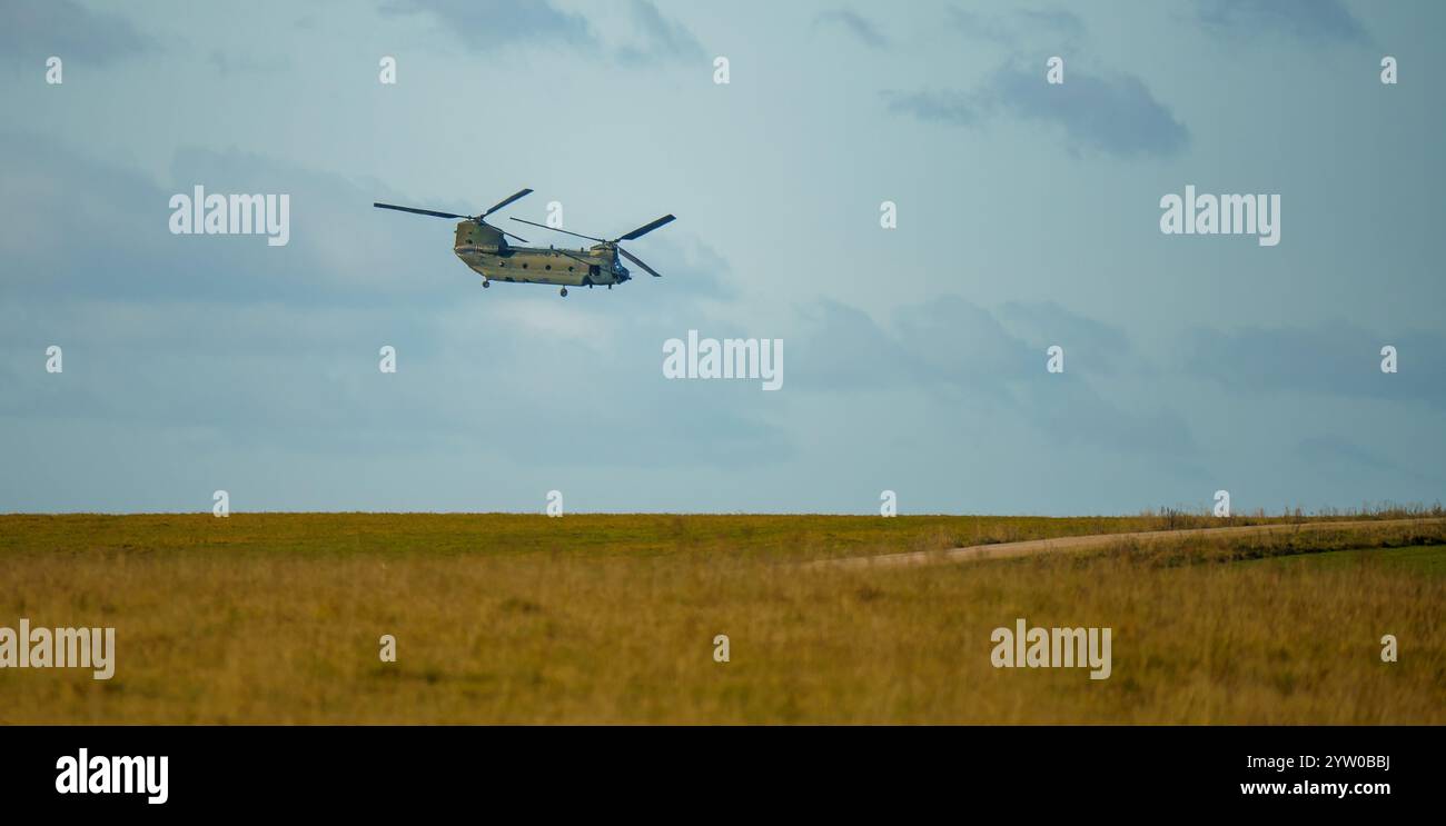 RAF Chinook tandem-rotor helicopter flying fast and low on a military ...