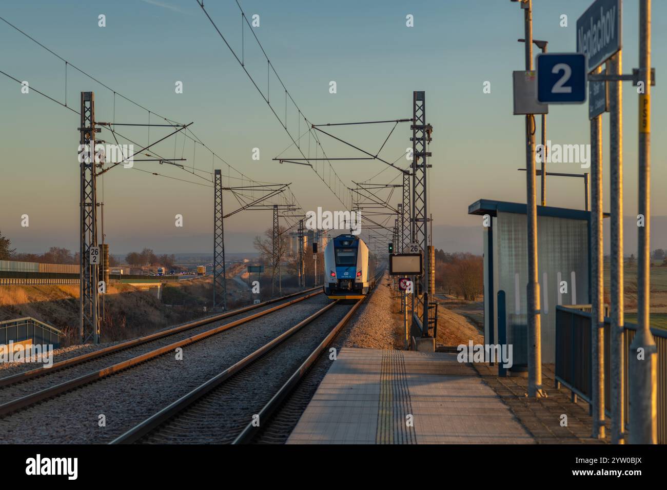 Fast railway electric tracks in cold winter fresh morning with fast ...