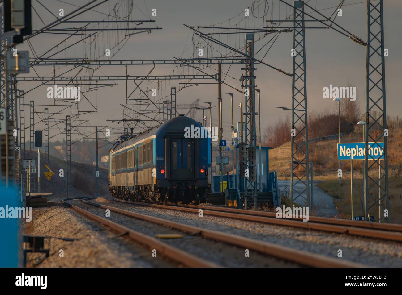 Fast railway electric tracks in cold winter fresh morning with fast ...