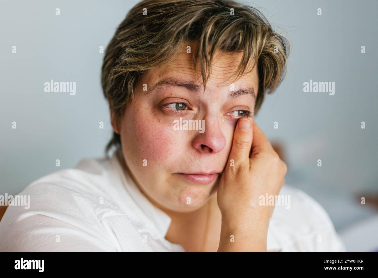 Sad woman touching her face and crying Stock Photo - Alamy