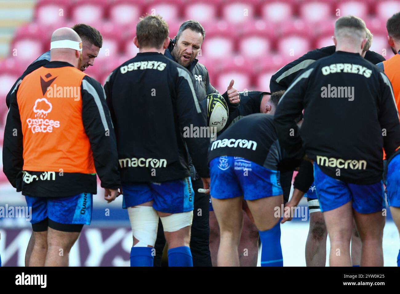 Llanelli, UK. 8 December, 2024. Ospreys coach Mark Jones talks to his ...