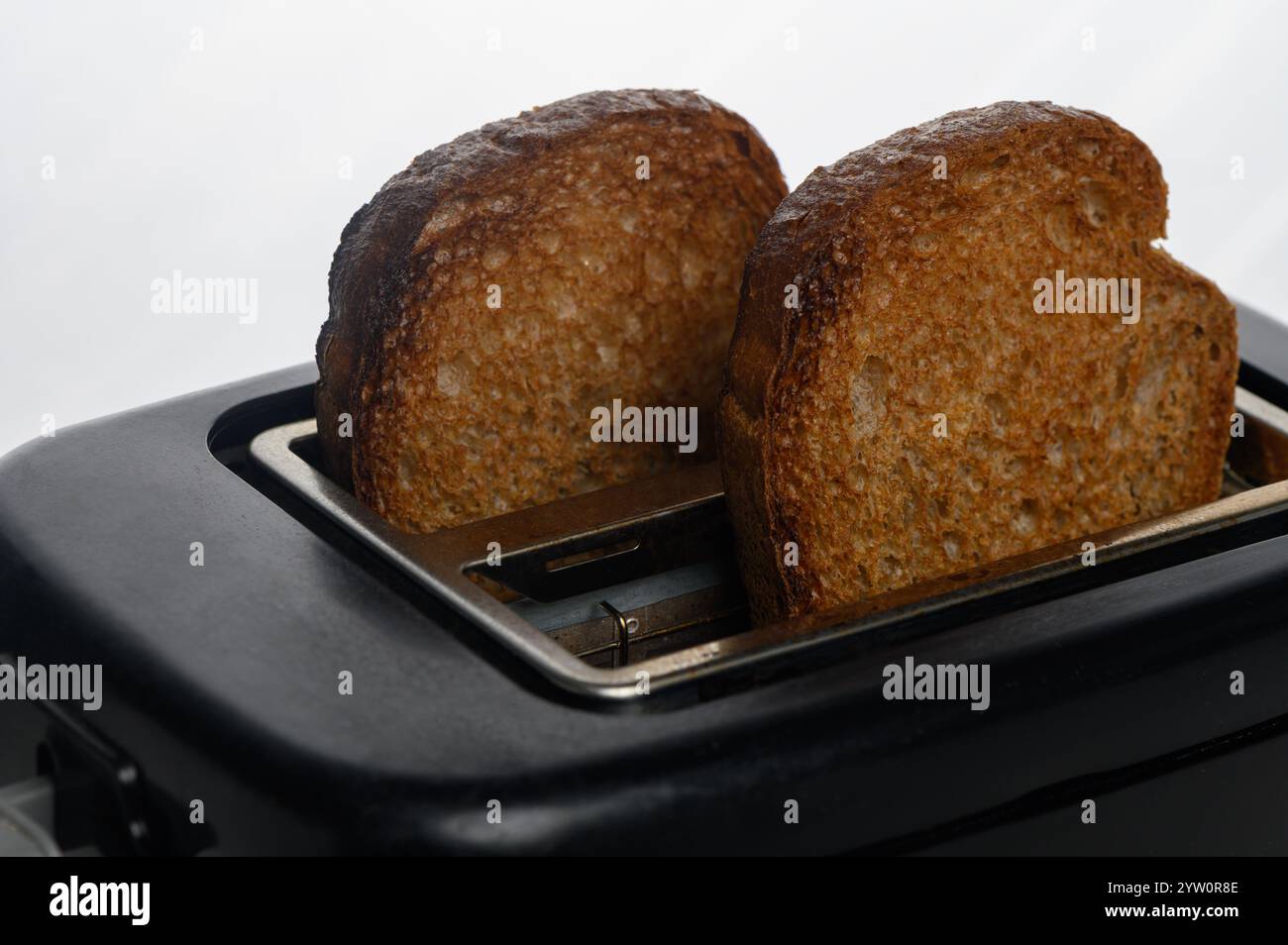 Slices of whole grain breadGolden brown toast popping up from a sleek ...