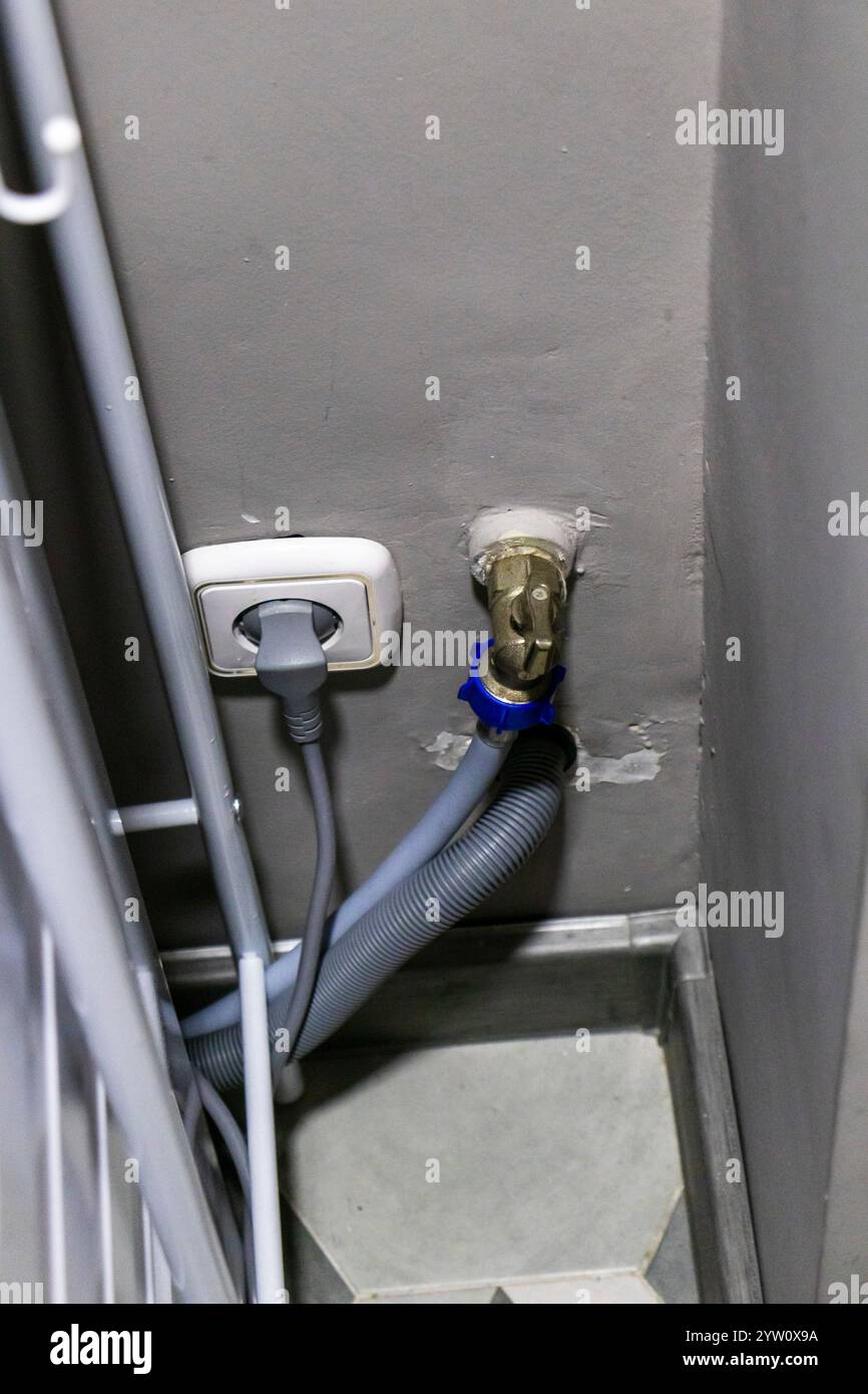 Electrical and plumbing washing machine connections Stock Photo - Alamy