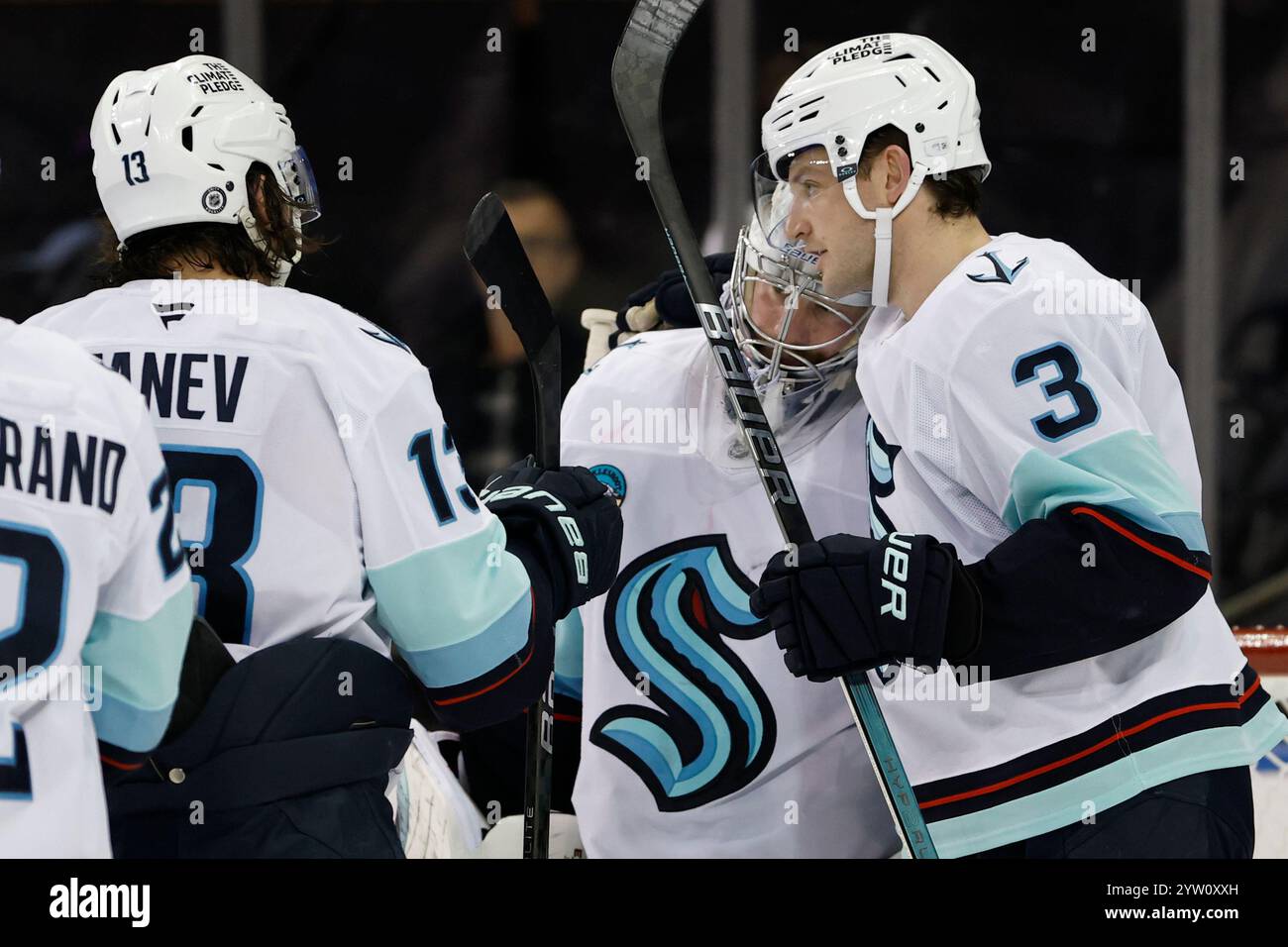 Seattle Kraken goaltender Philipp Grubauer, center, is congratulated by ...