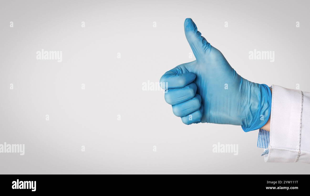 Hand in rubber gloved shows like sign Stock Photo - Alamy
