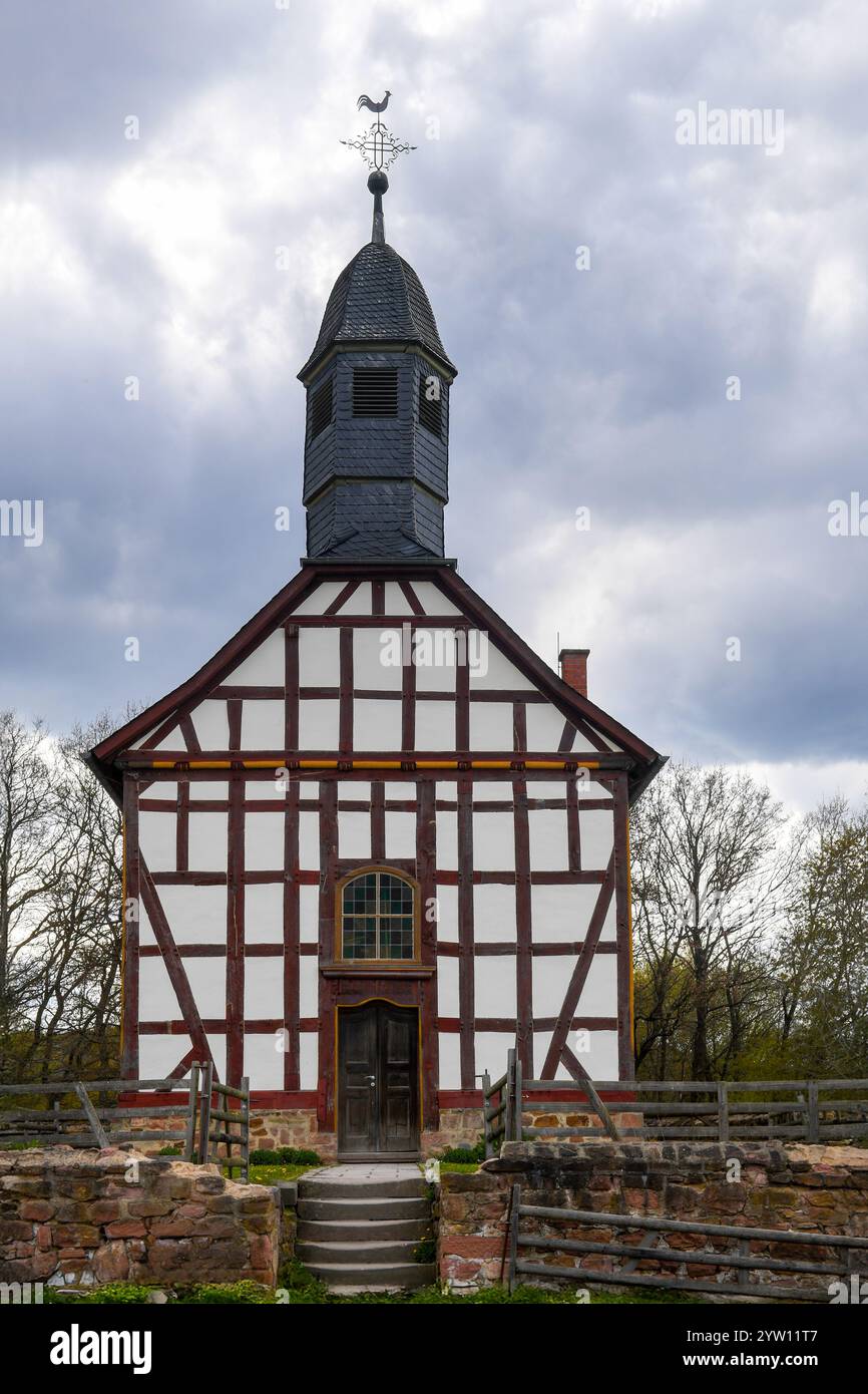 A historic half-timbered church with a slate roof and a small bell ...