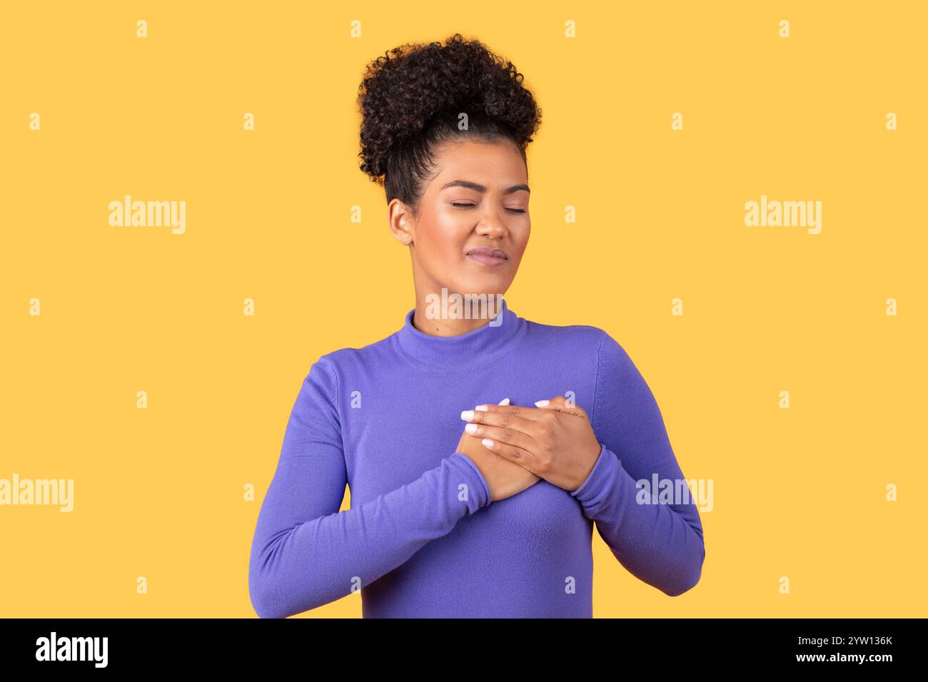 Joyful young Brazilian woman touching her chest Stock Photo - Alamy