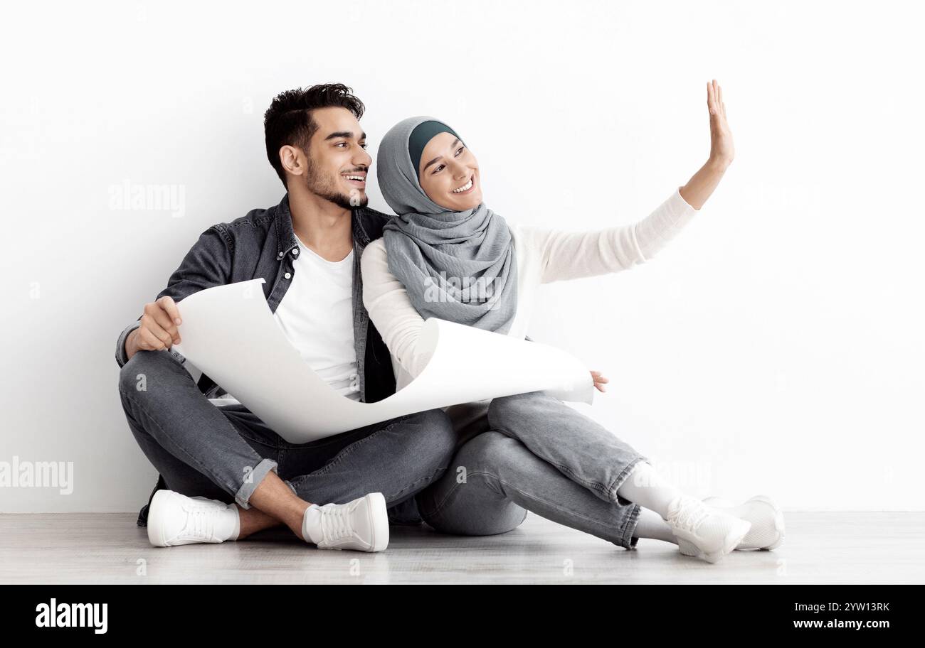 Emotional muslim family thinking about design in new house, panorama ...