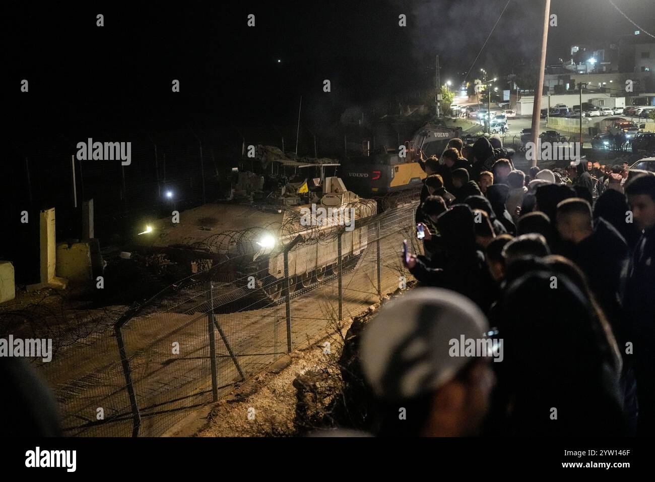 An Israeli armored vehicle maneuvers near the so-called Alpha Line that ...