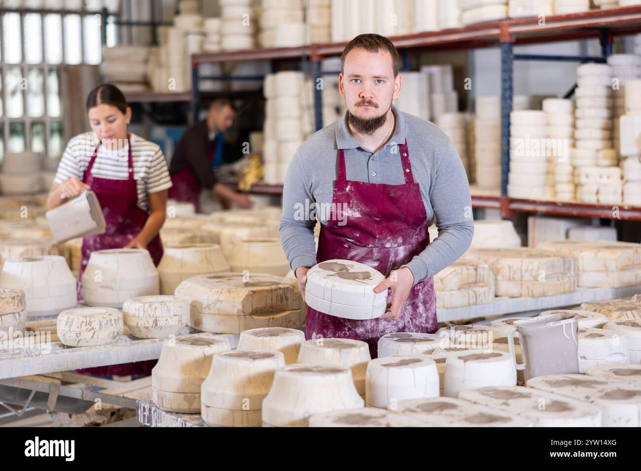 Ceramicist explaining use of slip casting molds in pottery making ...