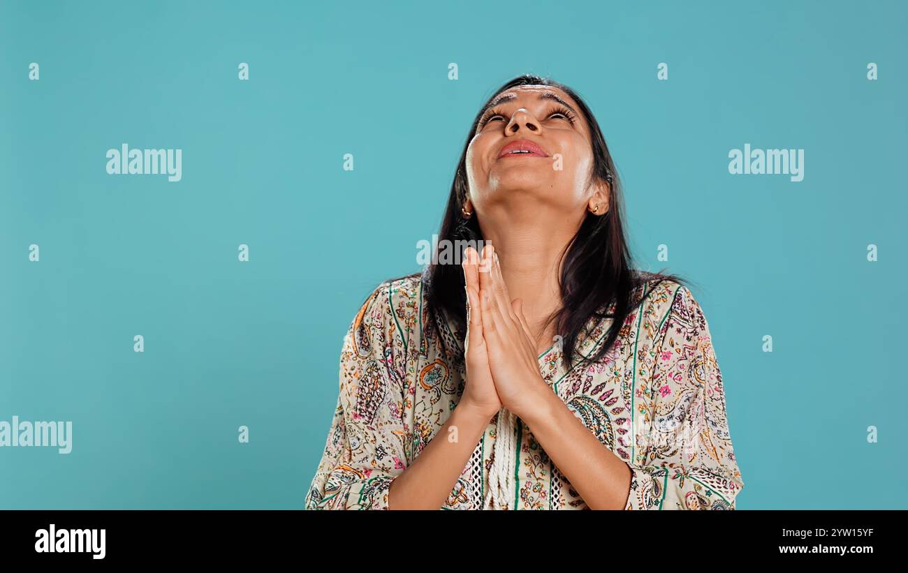 Indian woman putting hands together in begging gesture, making wish ...