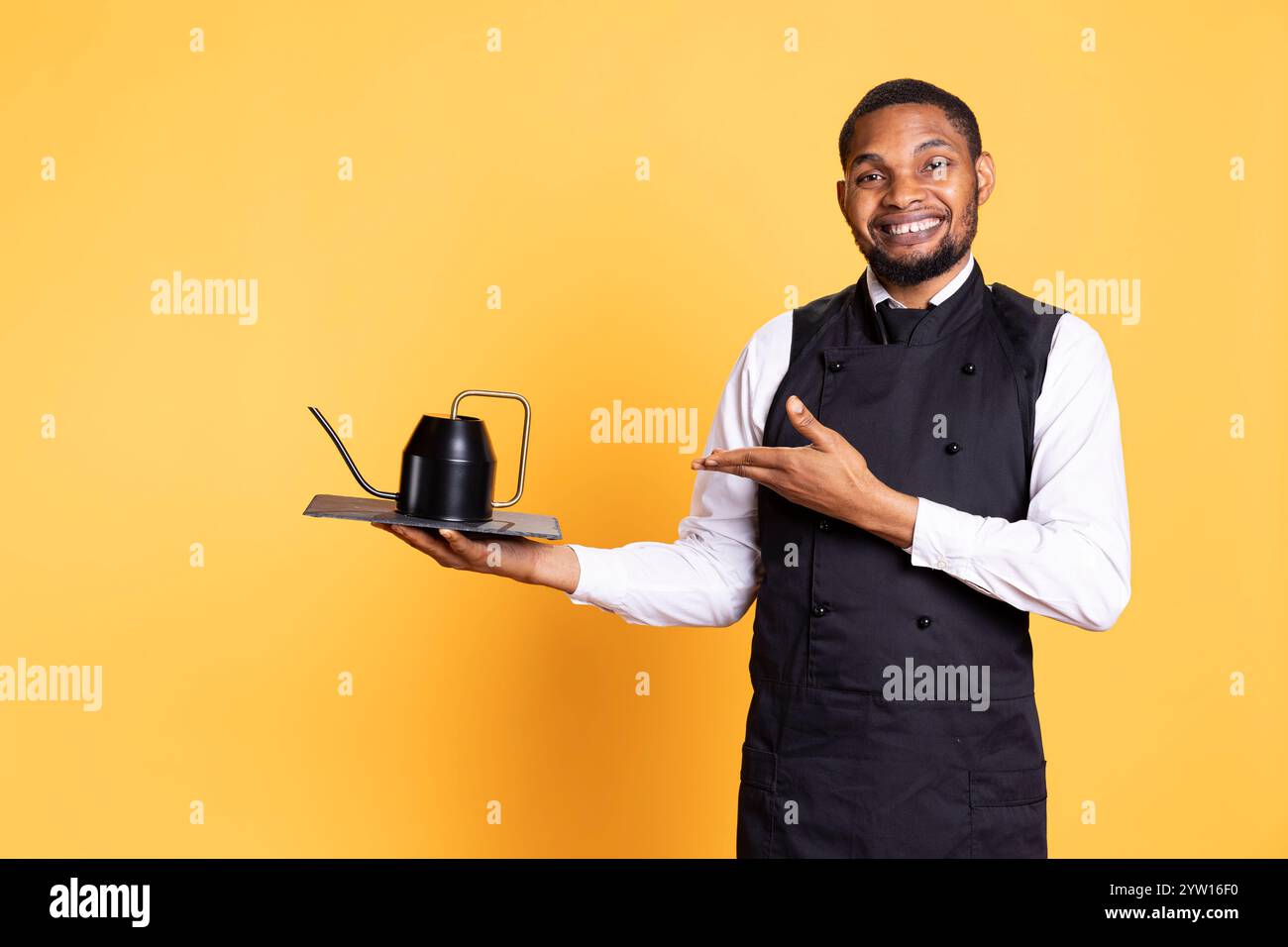 Restaurant butler serving people with tea before their dinner order ...
