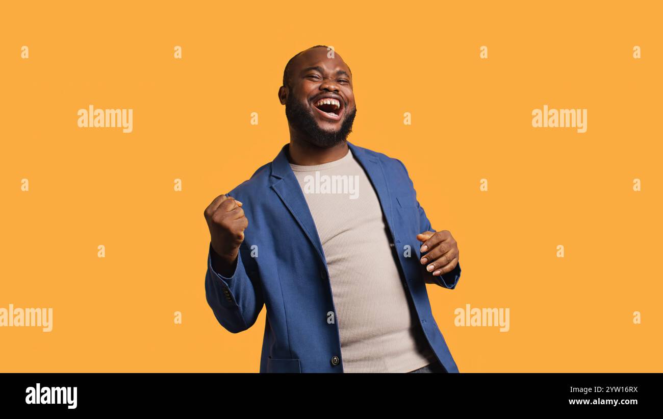 Portrait of joyful cheerful african american man celebrating, showing ...