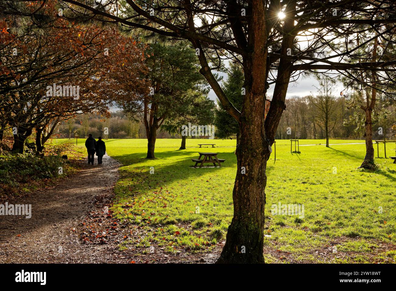 Couple wander along a path at Burrs Country Park, Bury, Lancashire ...
