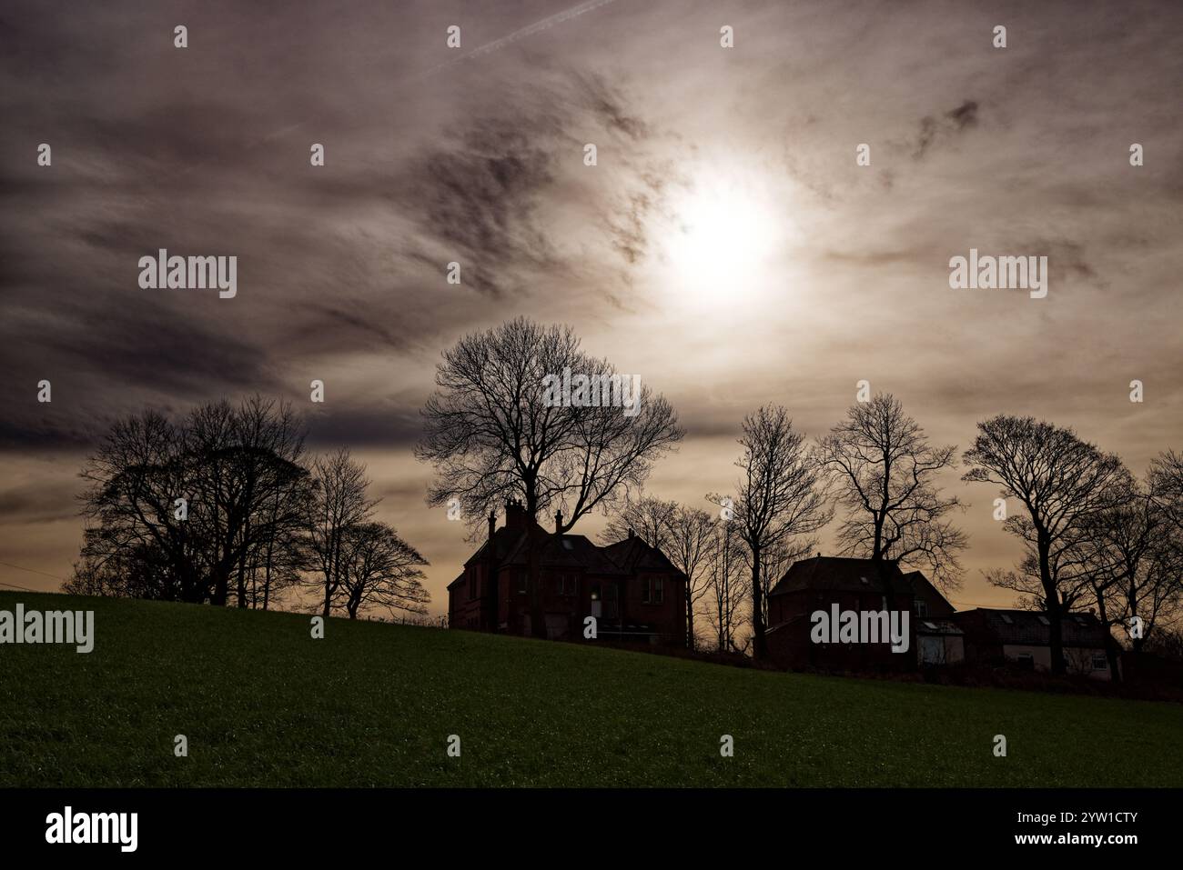 A powerfull winter sky silhouetting houses at Heywood, Rochdale ...