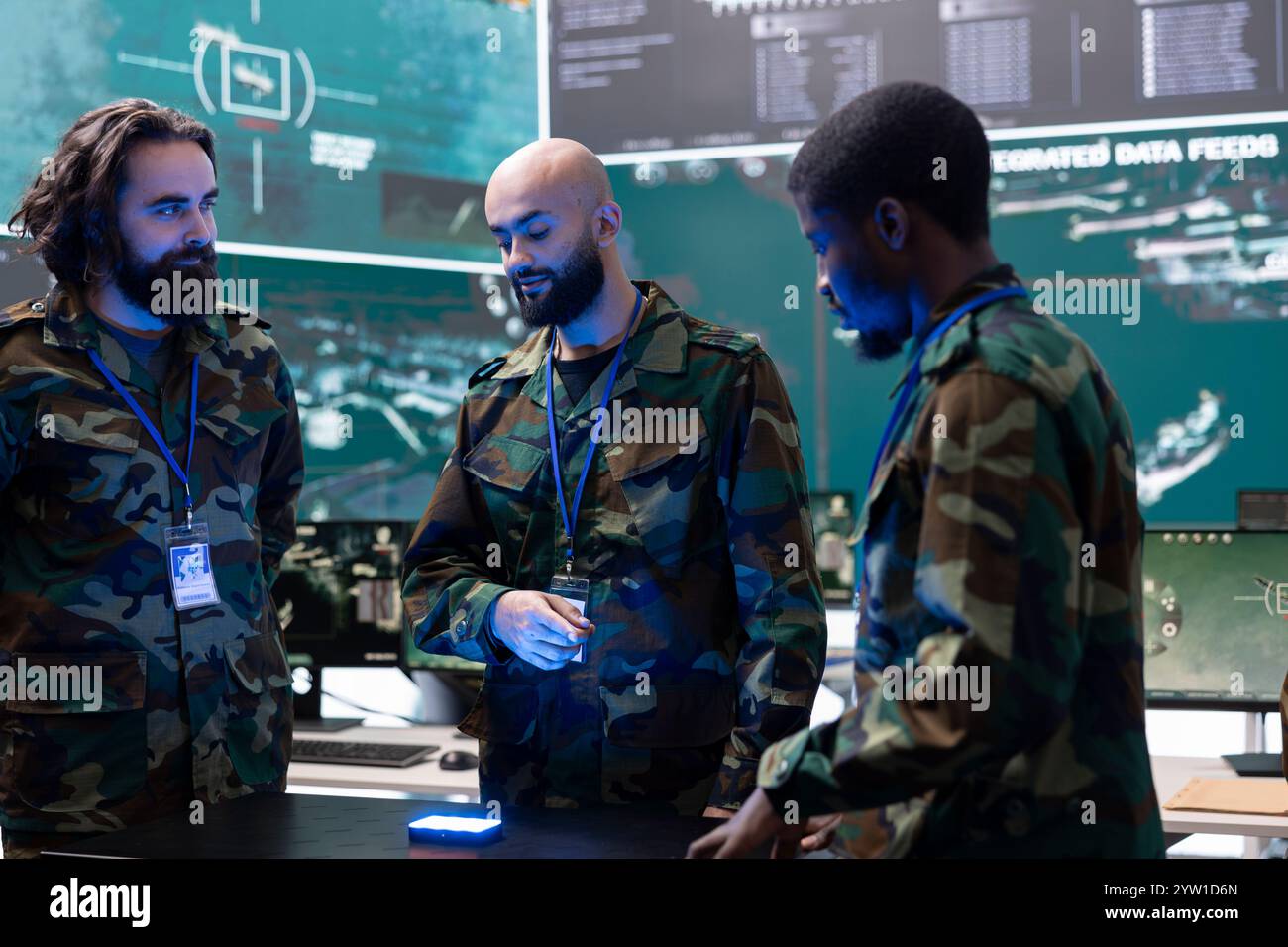 Diverse team of recruits examining information on a hologram, working ...