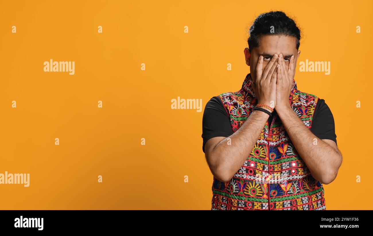 Anxious indian man covering face with palms, worried about future ...
