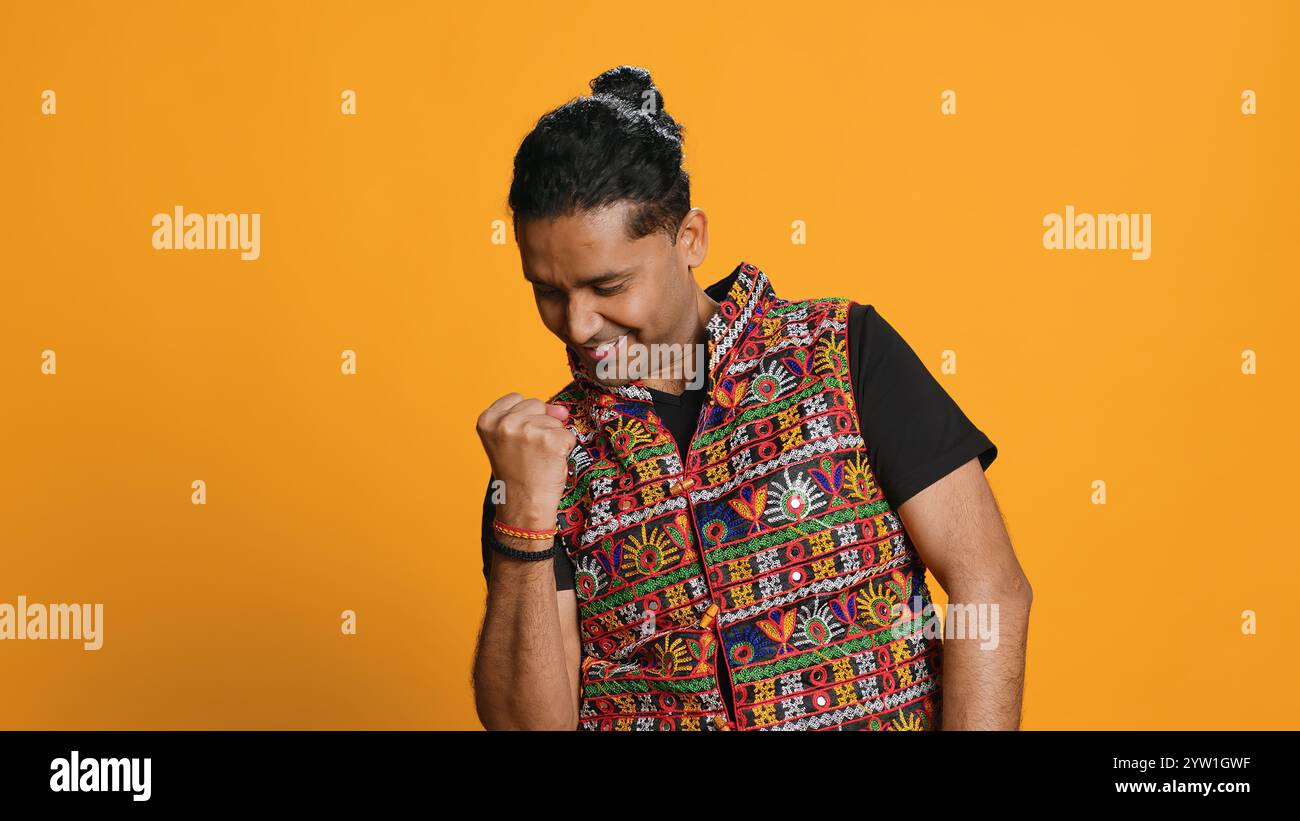 Portrait of joyful indian man celebrating, showing positive emotions ...