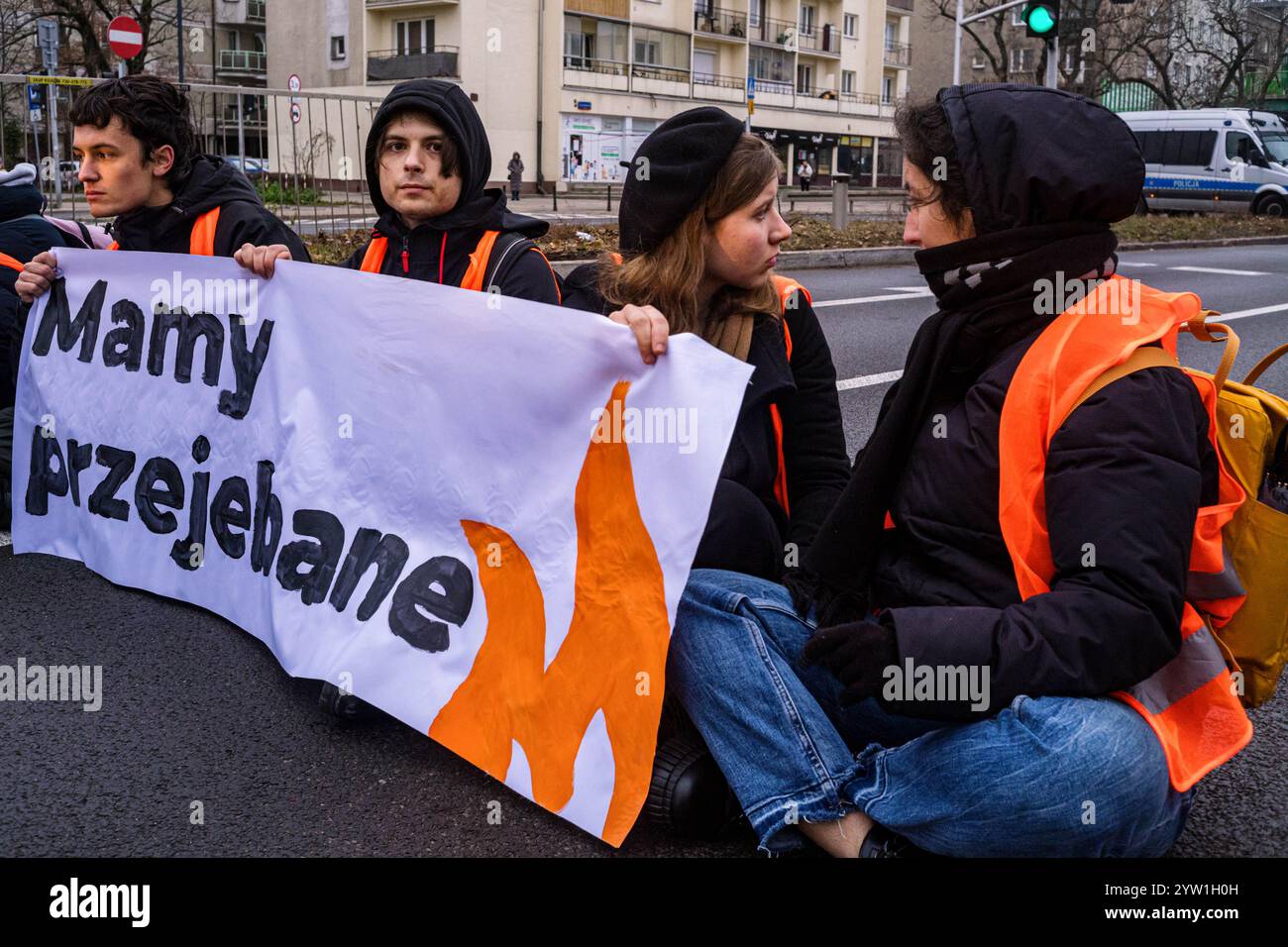 Climate activists block the road with a banner during the rally. The ...