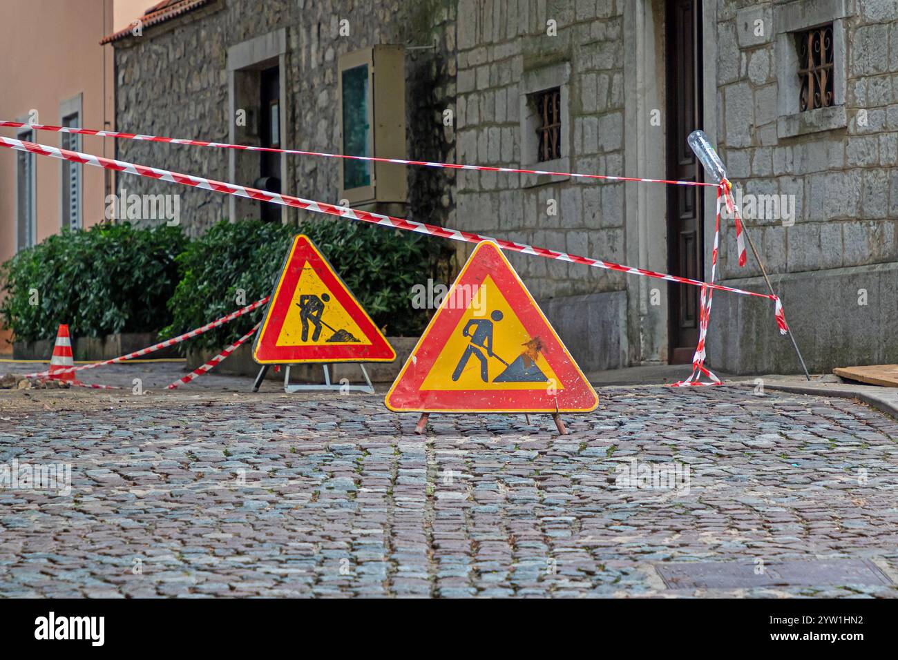 Road works on cobble stone street inside retro Italian city with ...