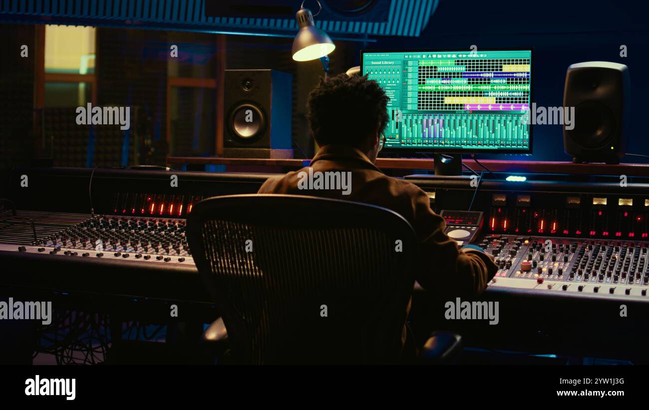 African american sound producer editing tracks on audio software and ...