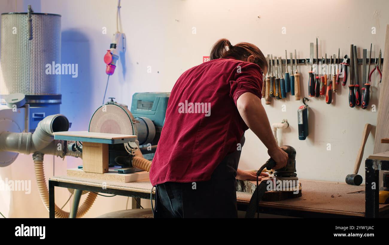 Carpenter making modifications on blueprint drawings, using angle ...