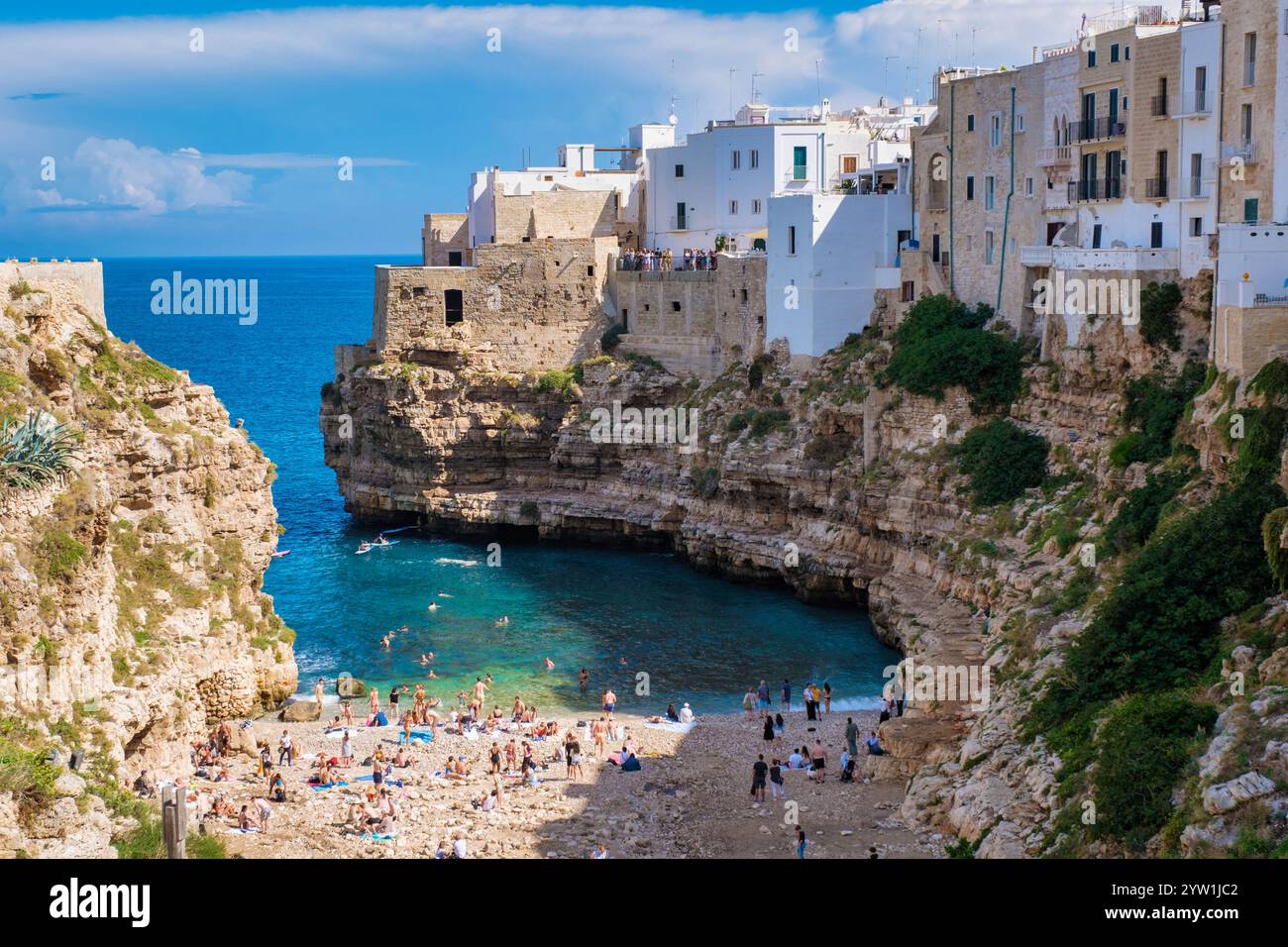 In the enchanting town of Polignano a Mare Italy, visitors relax on the ...